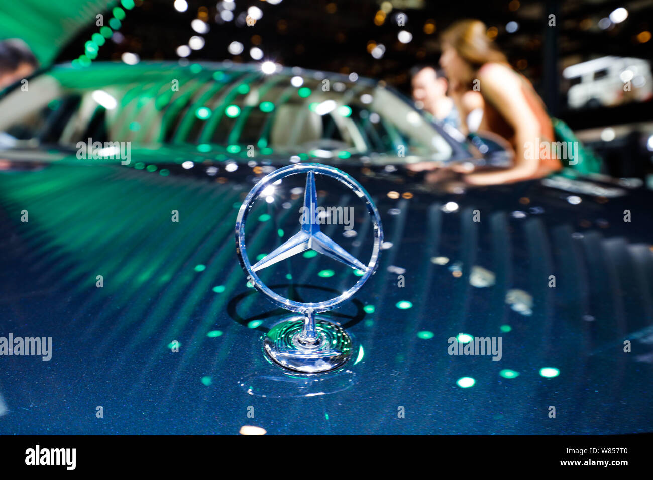 --FILE--Chinese visitors look at a Mercedes-Benz car on display during ...