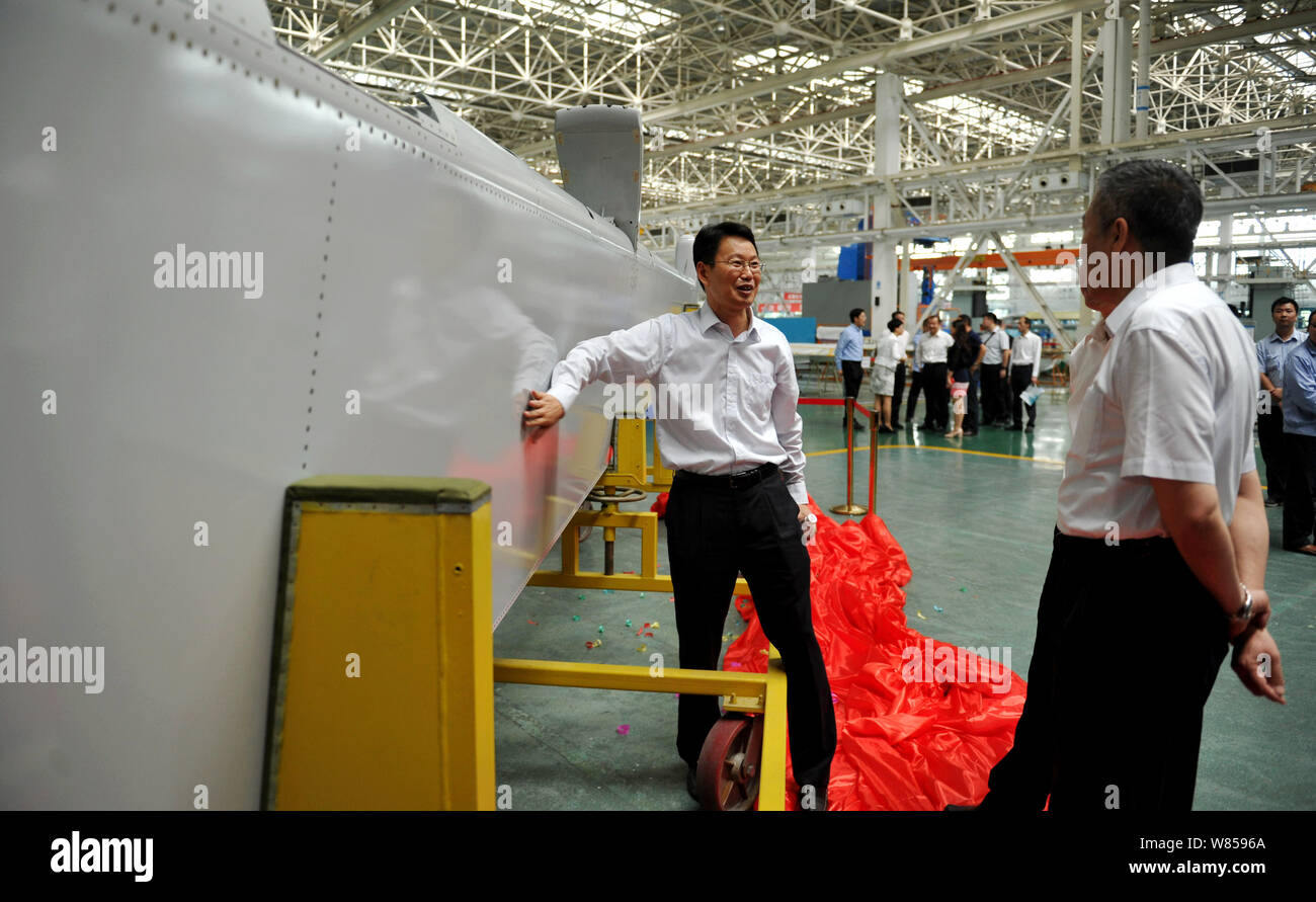 Guests look at the first rudder during the delivery ceremony of the ...
