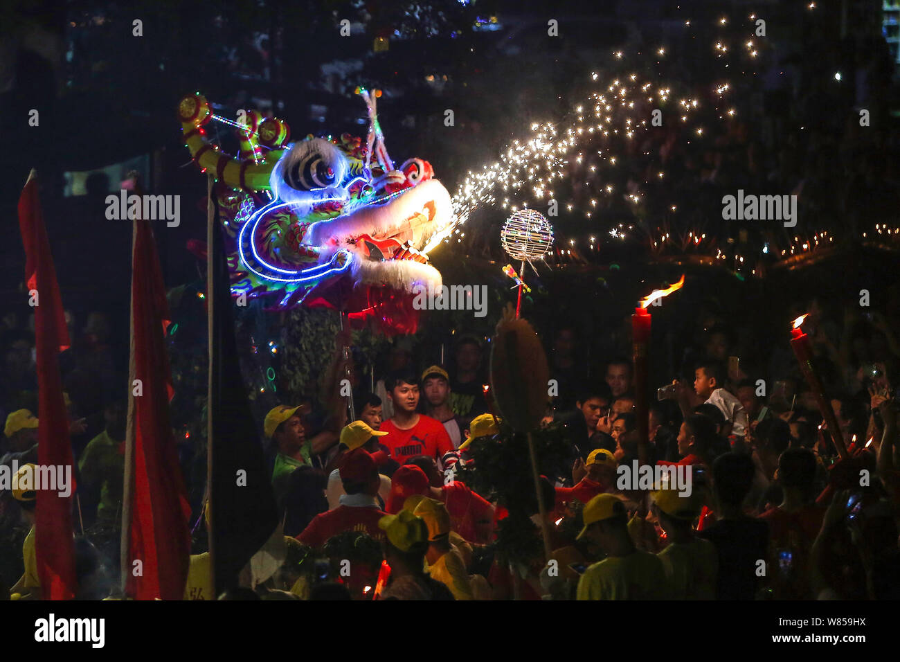 Chinese entertainers perform a fire dragon dance to celebrate the Mid ...