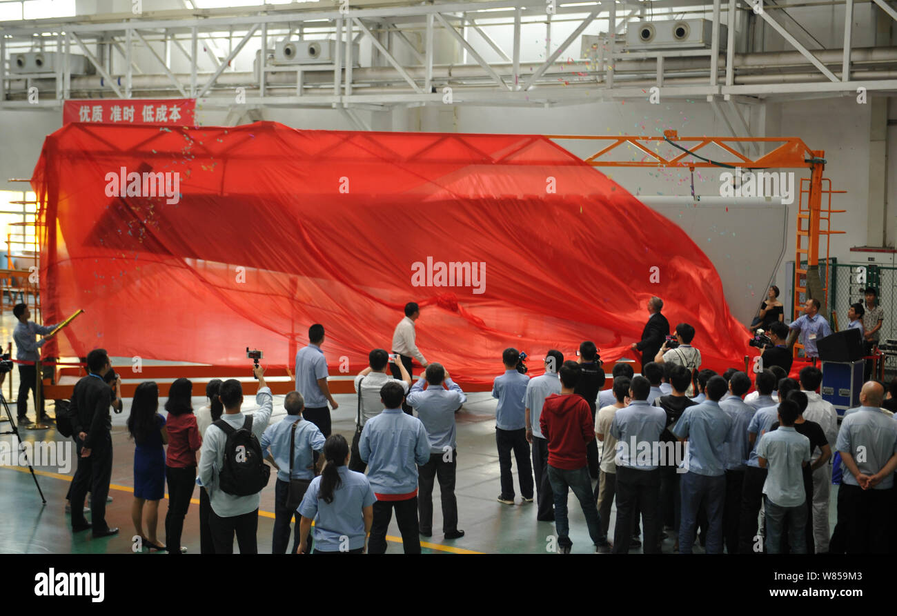Officials unveil the first rudder during the delivery ceremony of the ...