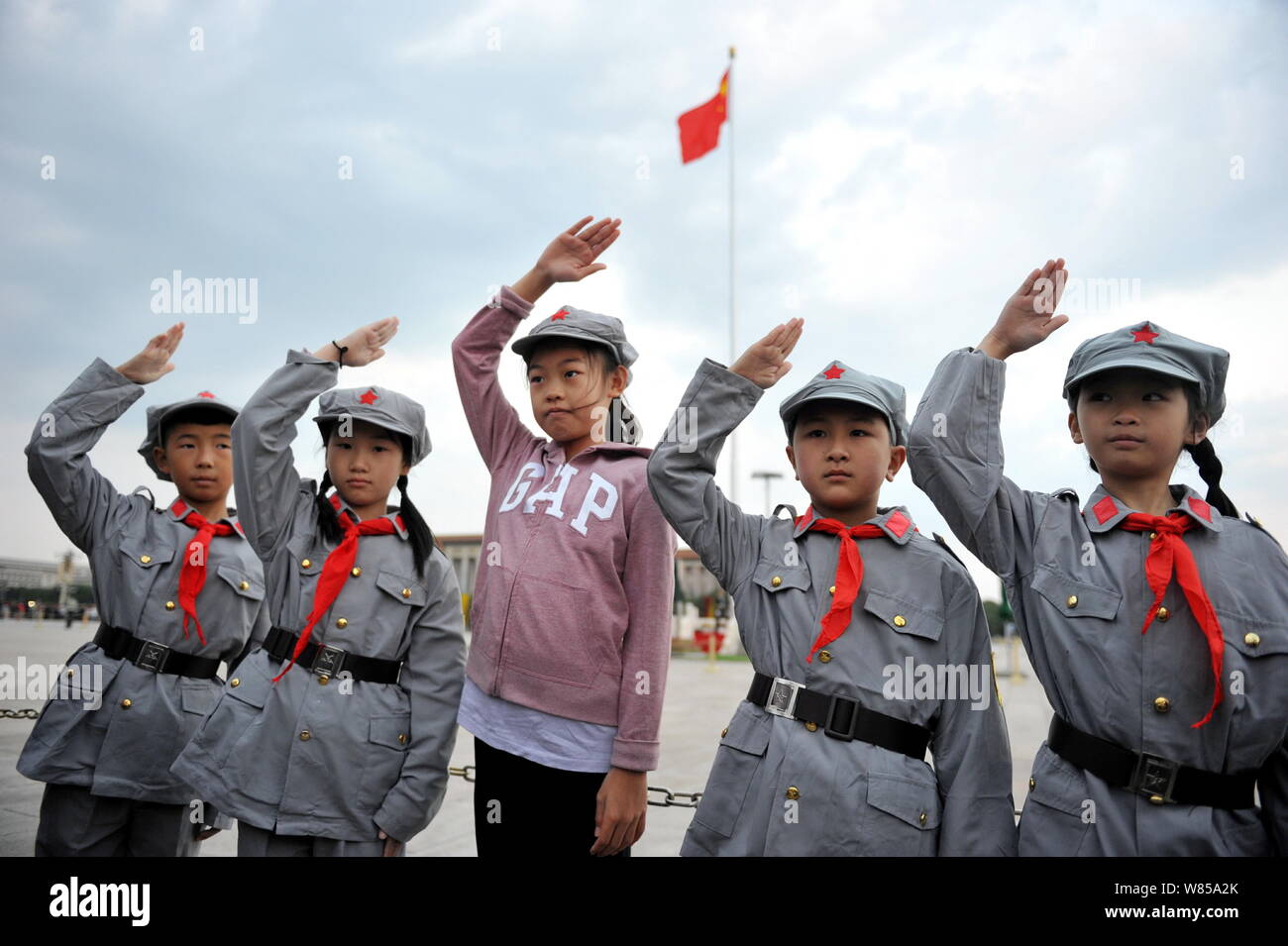 Chinese pupils dressed in "Red Army" costumes salute on the Tiananmen ...