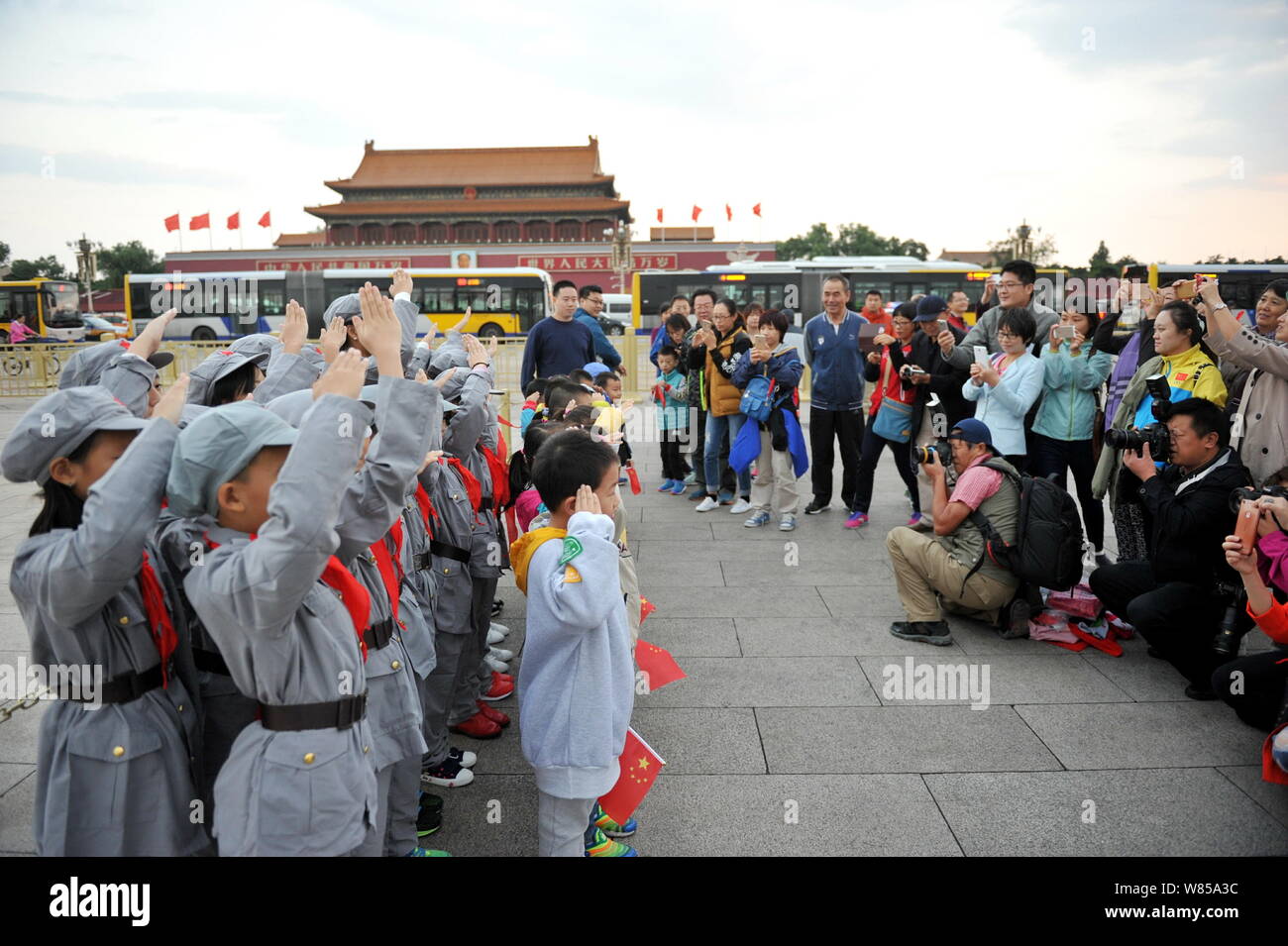 Chinese pupils dressed in "Red Army" costumes salute on the Tiananmen ...