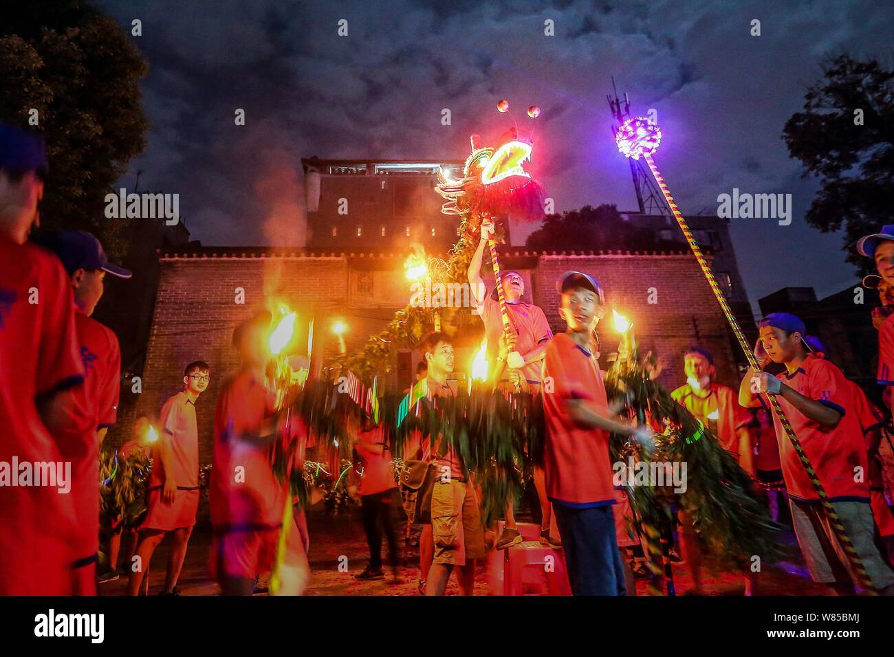 Chinese entertainers perform a fire dragon dance to celebrate the Mid ...