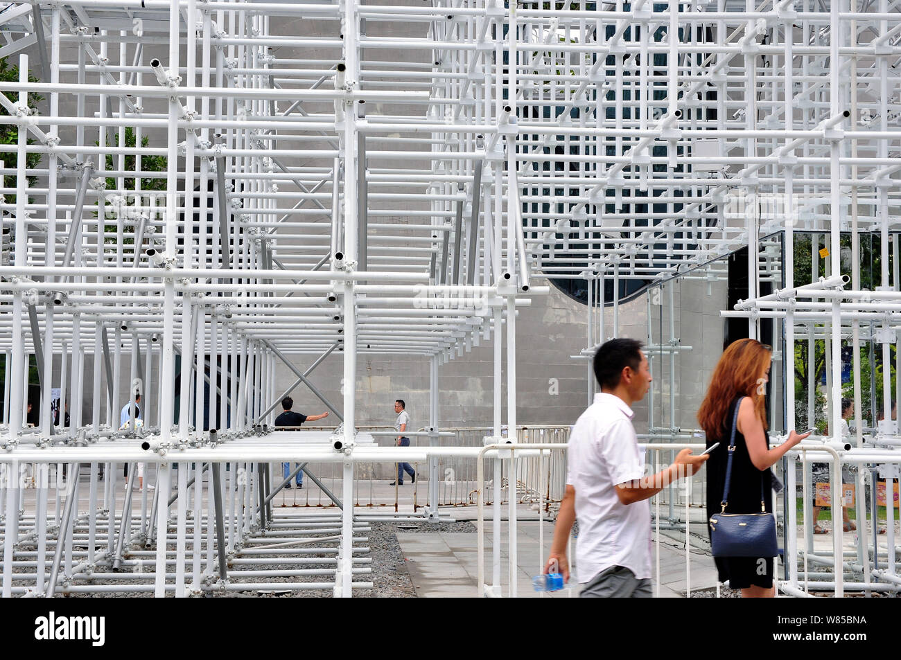 People walk past the landmark building "Envision Pavilion" designed by ...
