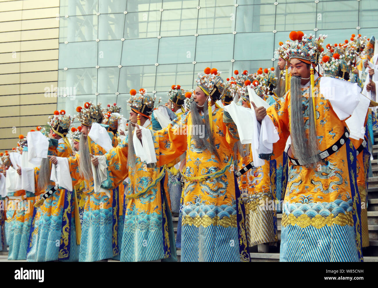 Chinese Opera artists and fans, wearing imperial robes, perform to set ...