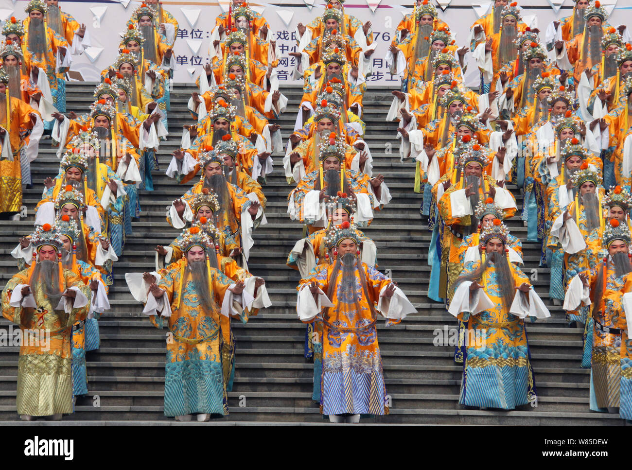 Chinese Opera artists and fans, wearing imperial robes, perform to set ...