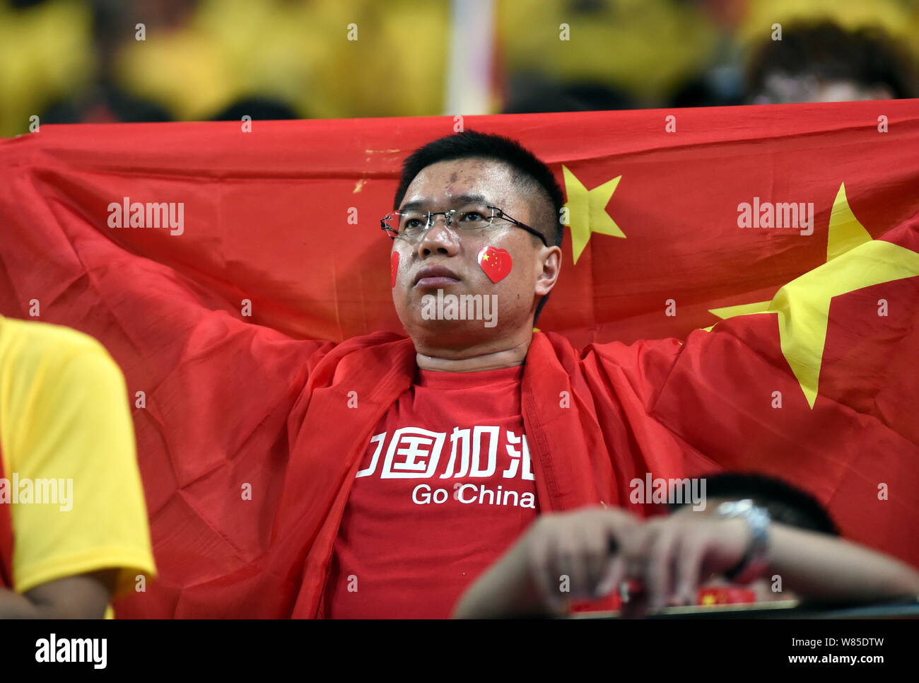 A Chinese football fan displays a national flag to show support for the ...