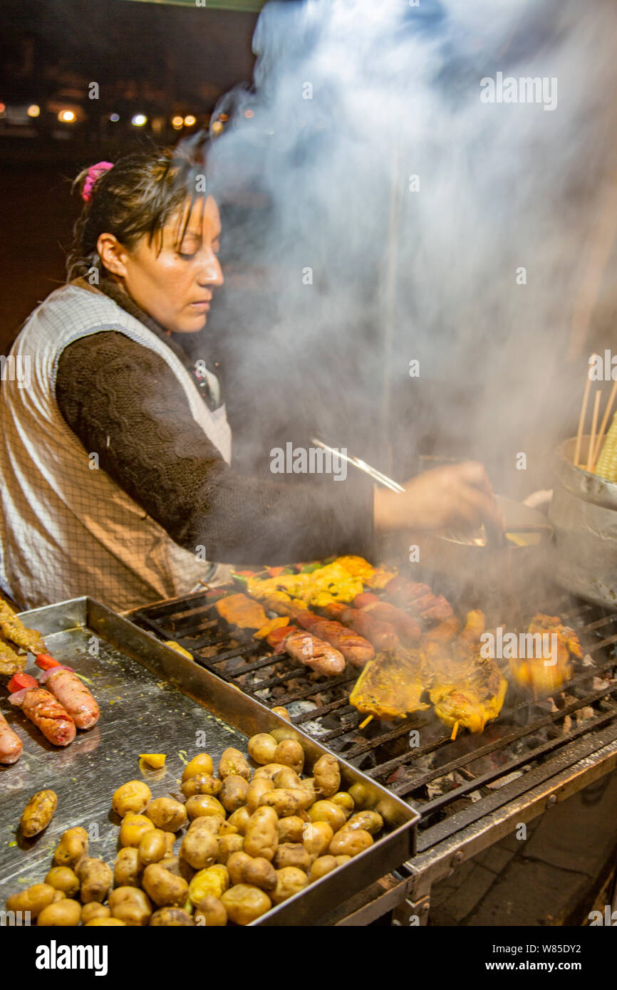 Cuenca, Ecuador - Street food vendor prepares shish kabob of sausage ...