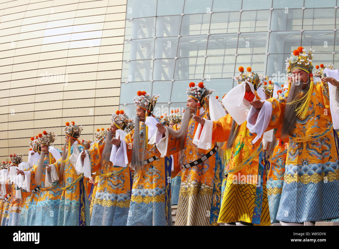 Chinese Opera artists and fans, wearing imperial robes, perform to set ...