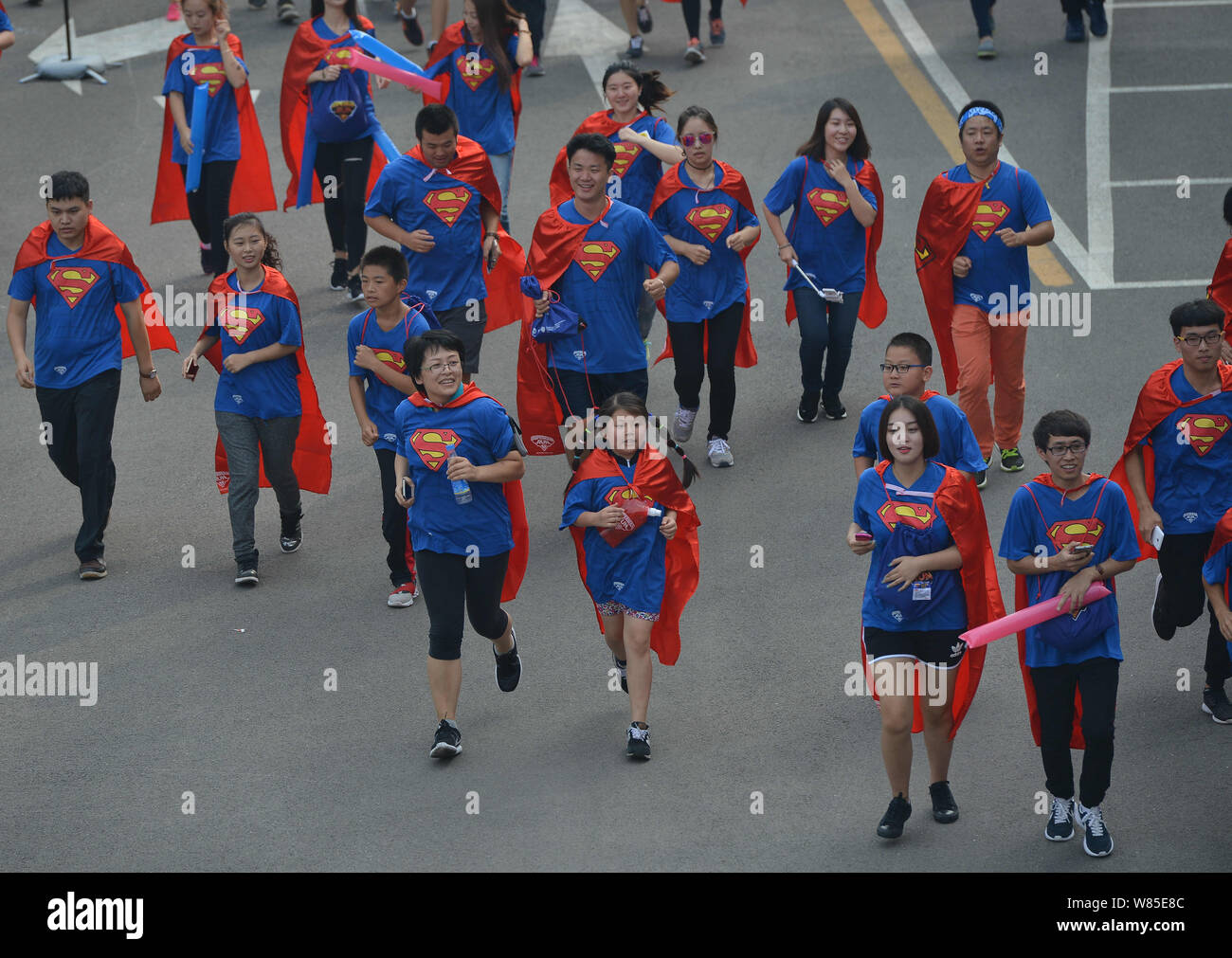 Participants dressed in costumes of Superman take part in the Shenyang ...