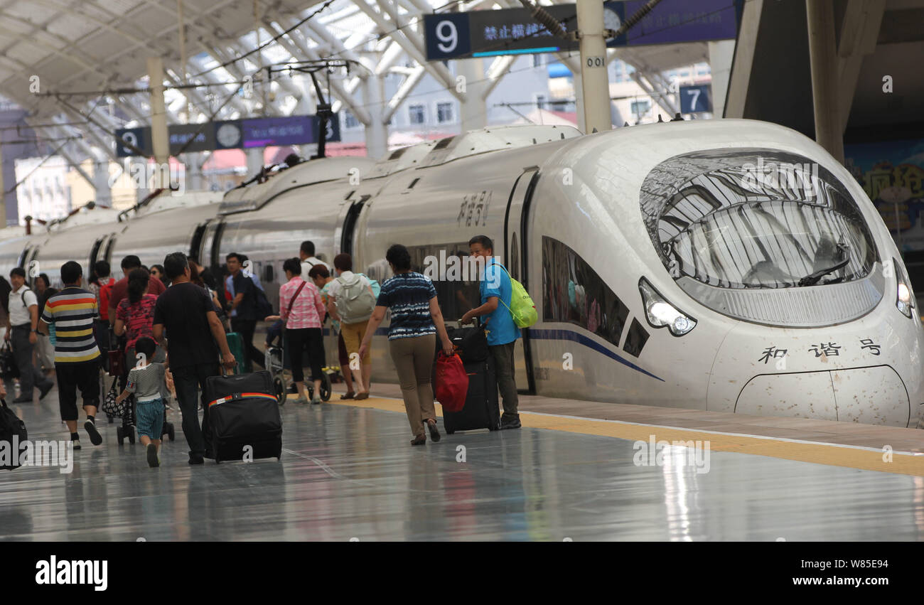 --FILE--Chinese passengers exit from a CRH (China Railway High-speed) bullet train at the ...
