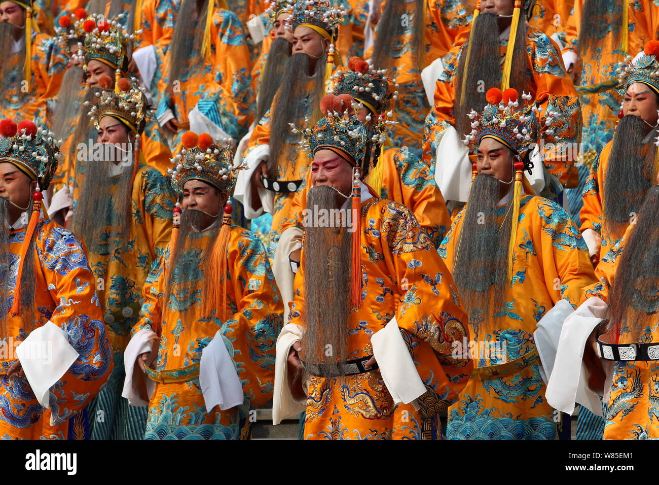 Chinese Opera artists and fans, wearing imperial robes, perform to set ...