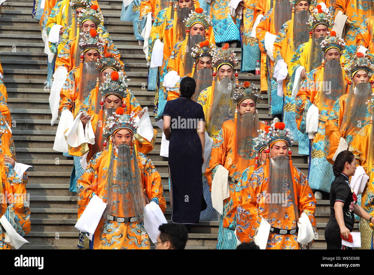 Chinese Opera artists and fans, wearing imperial robes, perform to set ...
