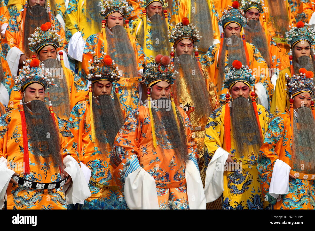 Chinese Opera artists and fans, wearing imperial robes, perform to set ...