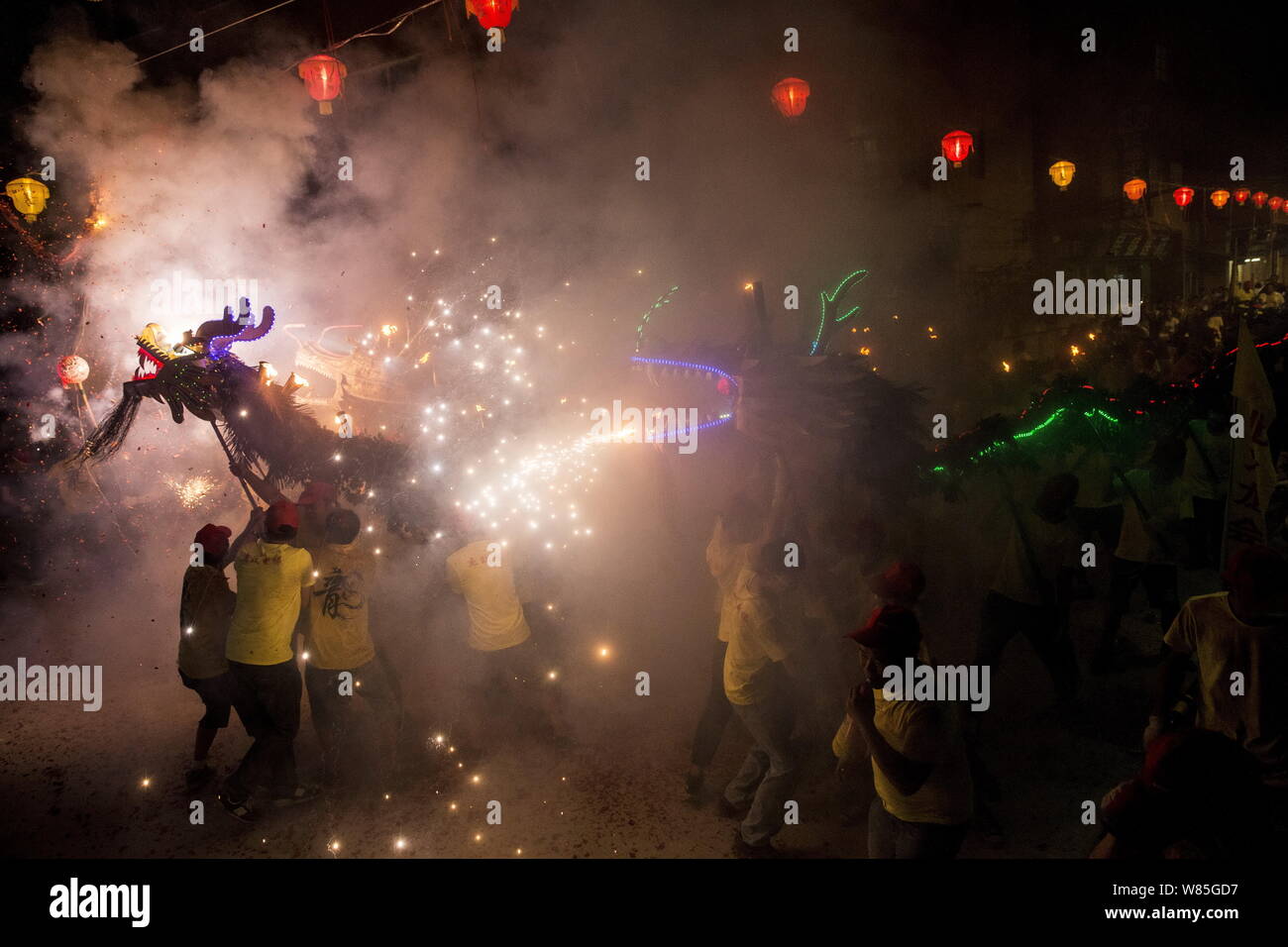 Chinese entertainers perform a fire dragon dance to celebrate the Mid ...