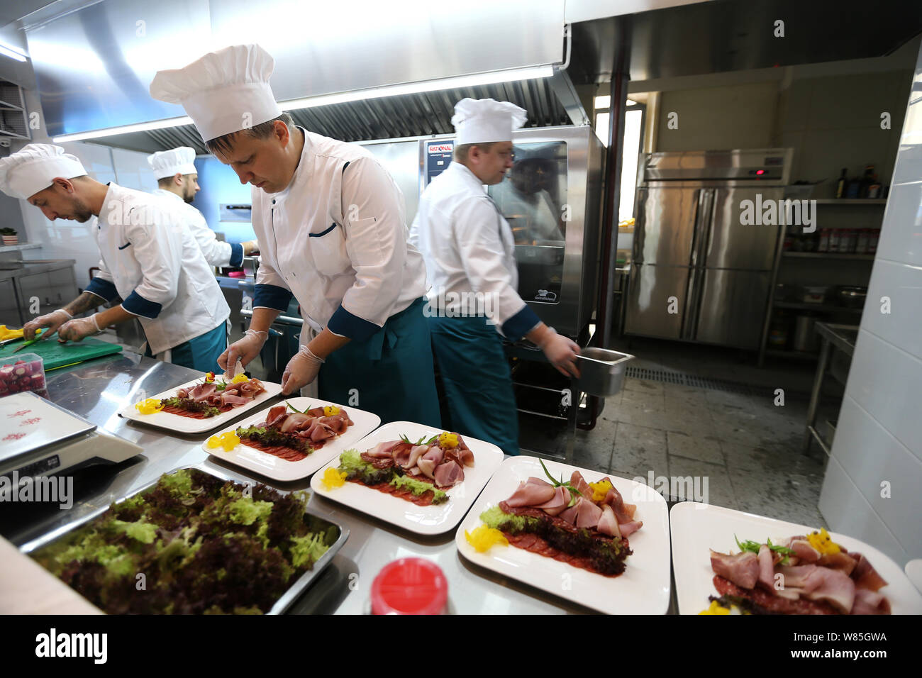 Chefs prepare food for customers on the Boeing 737-400 airplane ...