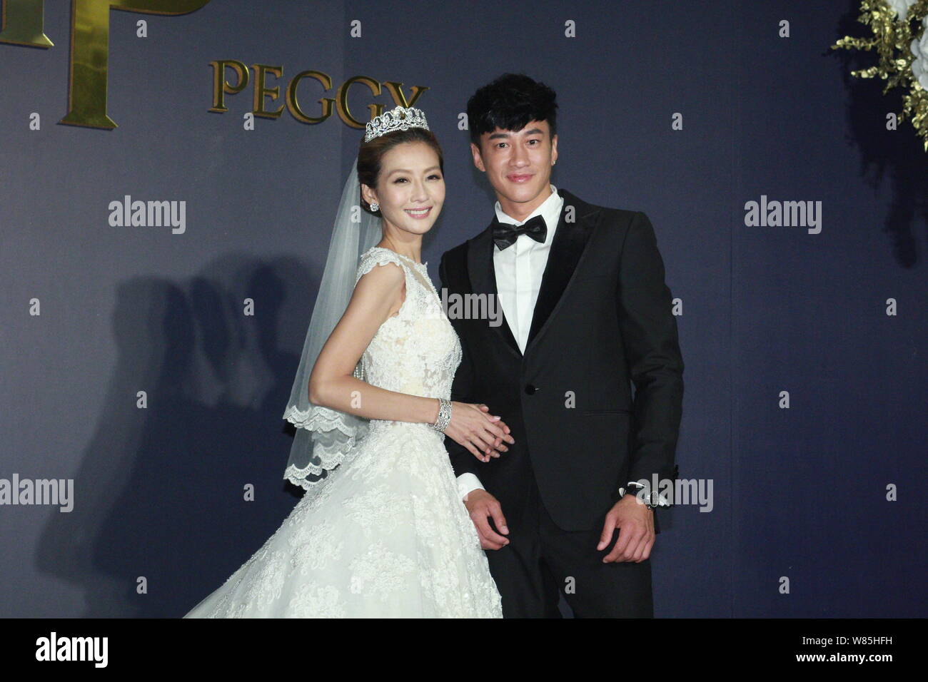 Taiwanese actor Peter Ho poses with his wife Peggy during their wedding ...