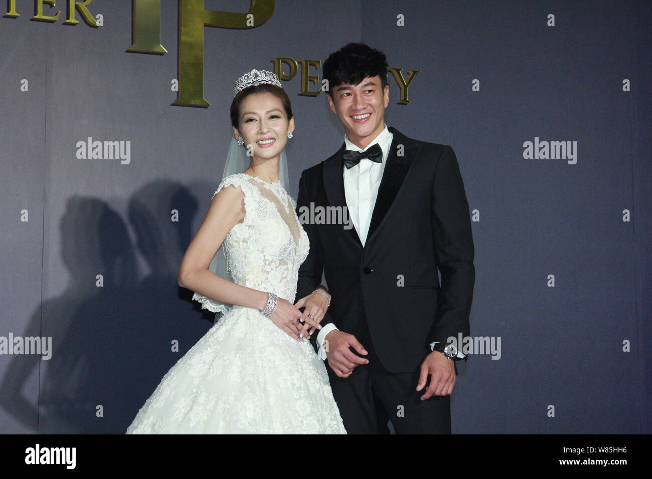 Taiwanese actor Peter Ho poses with his wife Peggy during their wedding ...