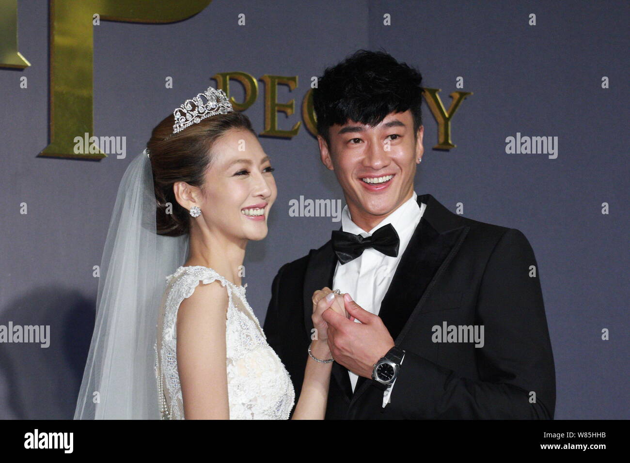 Taiwanese actor Peter Ho poses with his wife Peggy during their wedding ...