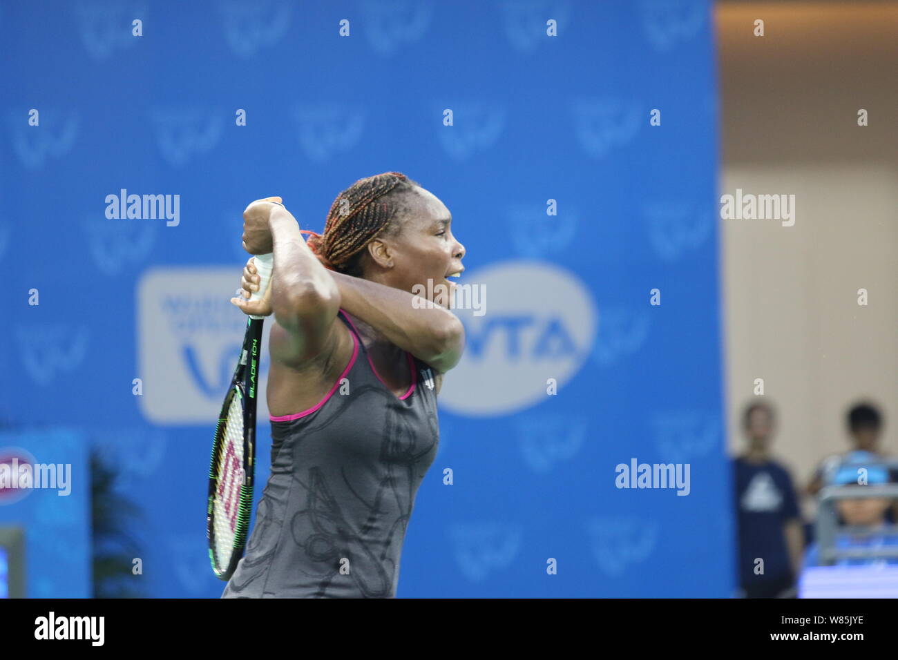 Venus Williams of the United States returns a shot to Yulia Putintseva ...