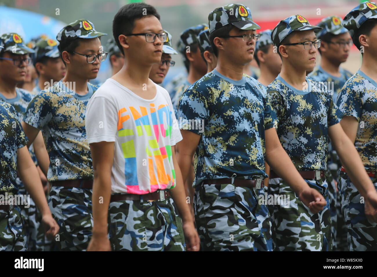 Chinese freshmen students take part in a military training session at a ...