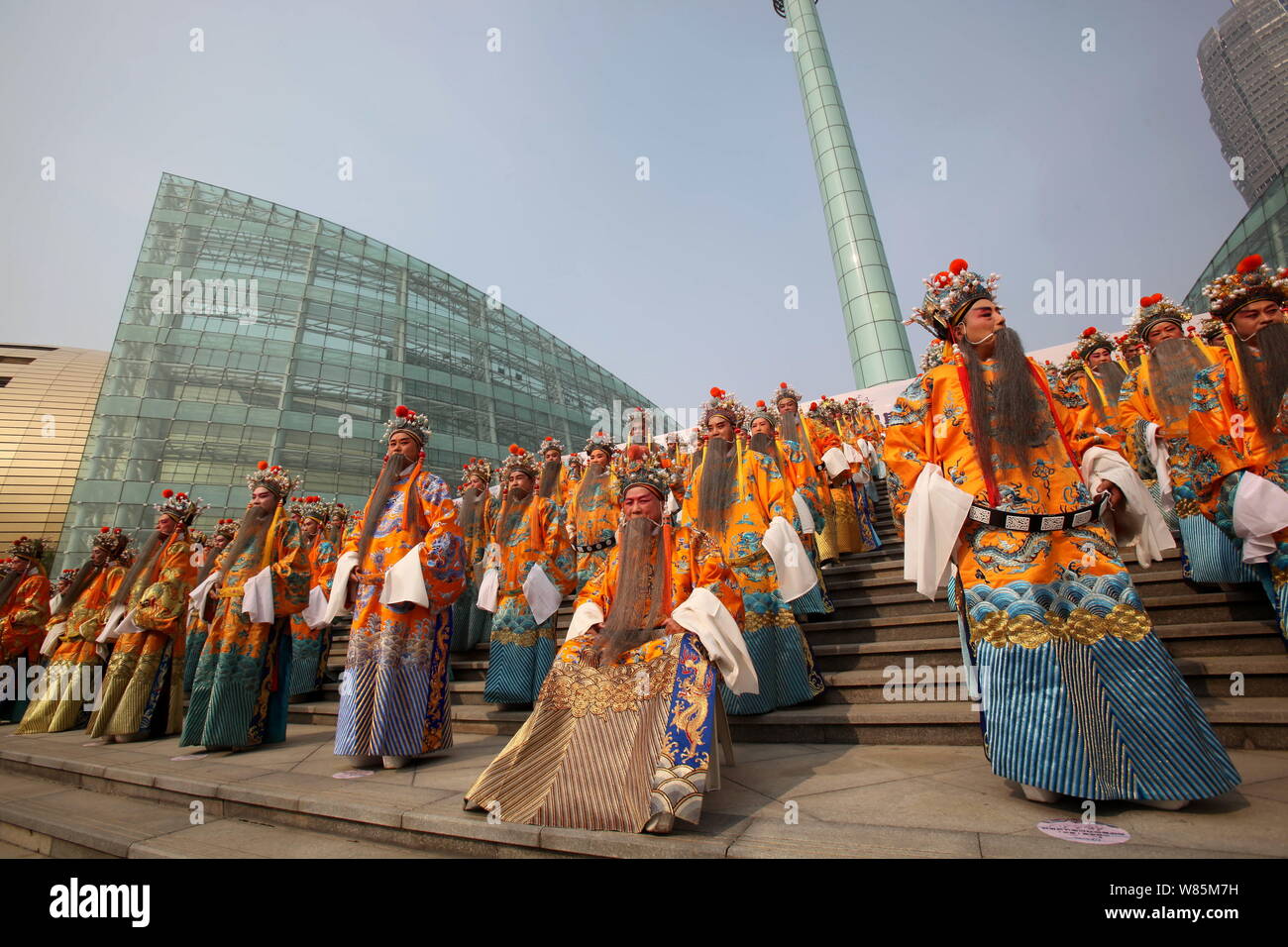 Chinese Opera artists and fans, wearing imperial robes, perform to set ...