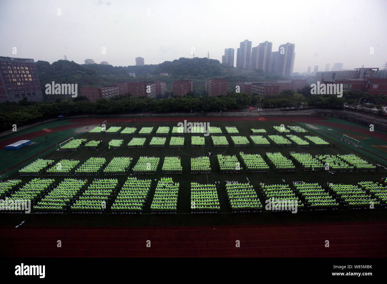 Young Chinese students wearing fluorescent uniforms take part in a ...