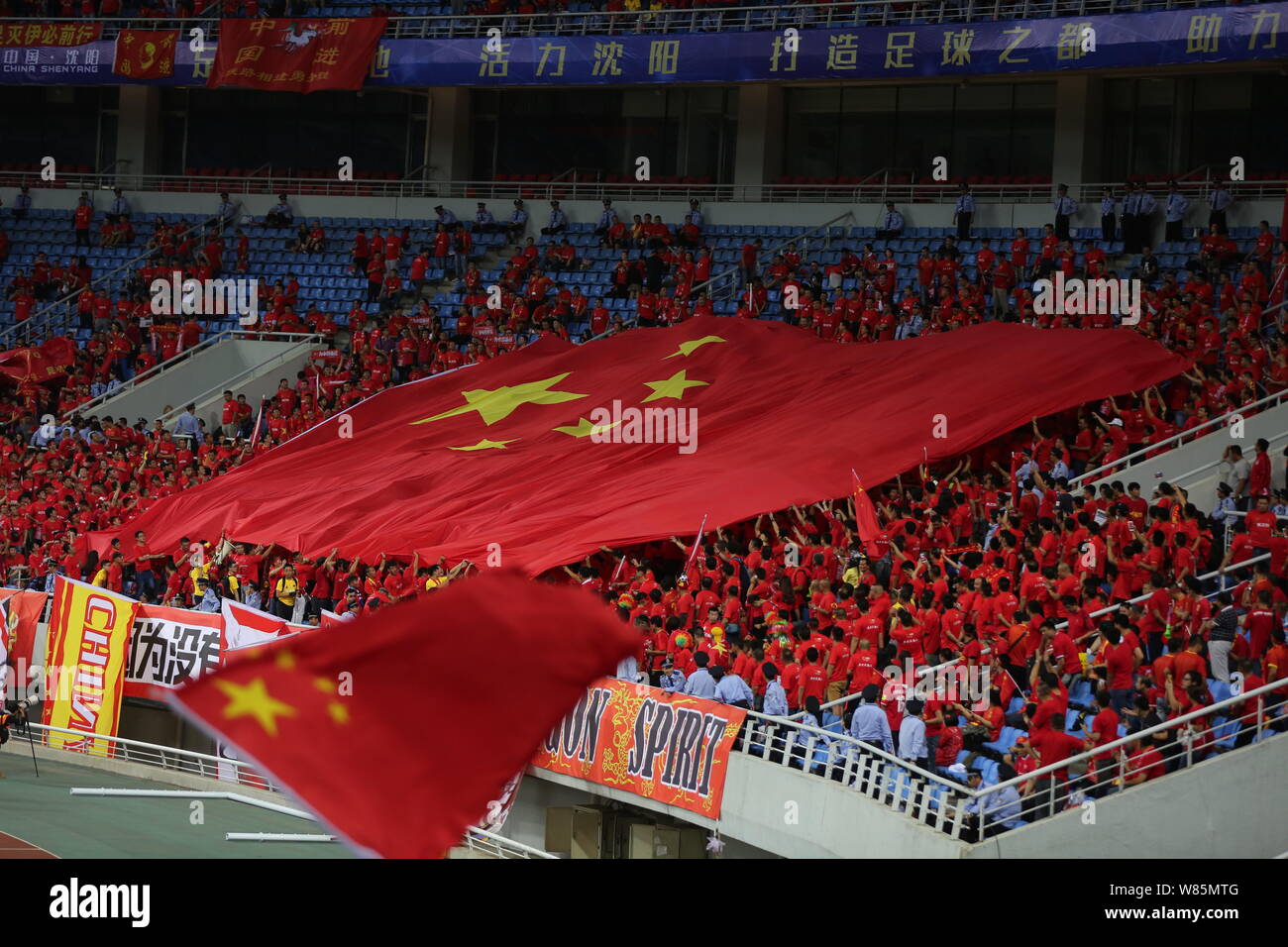 Chinese football fans pass on a giant national flag to show support for ...