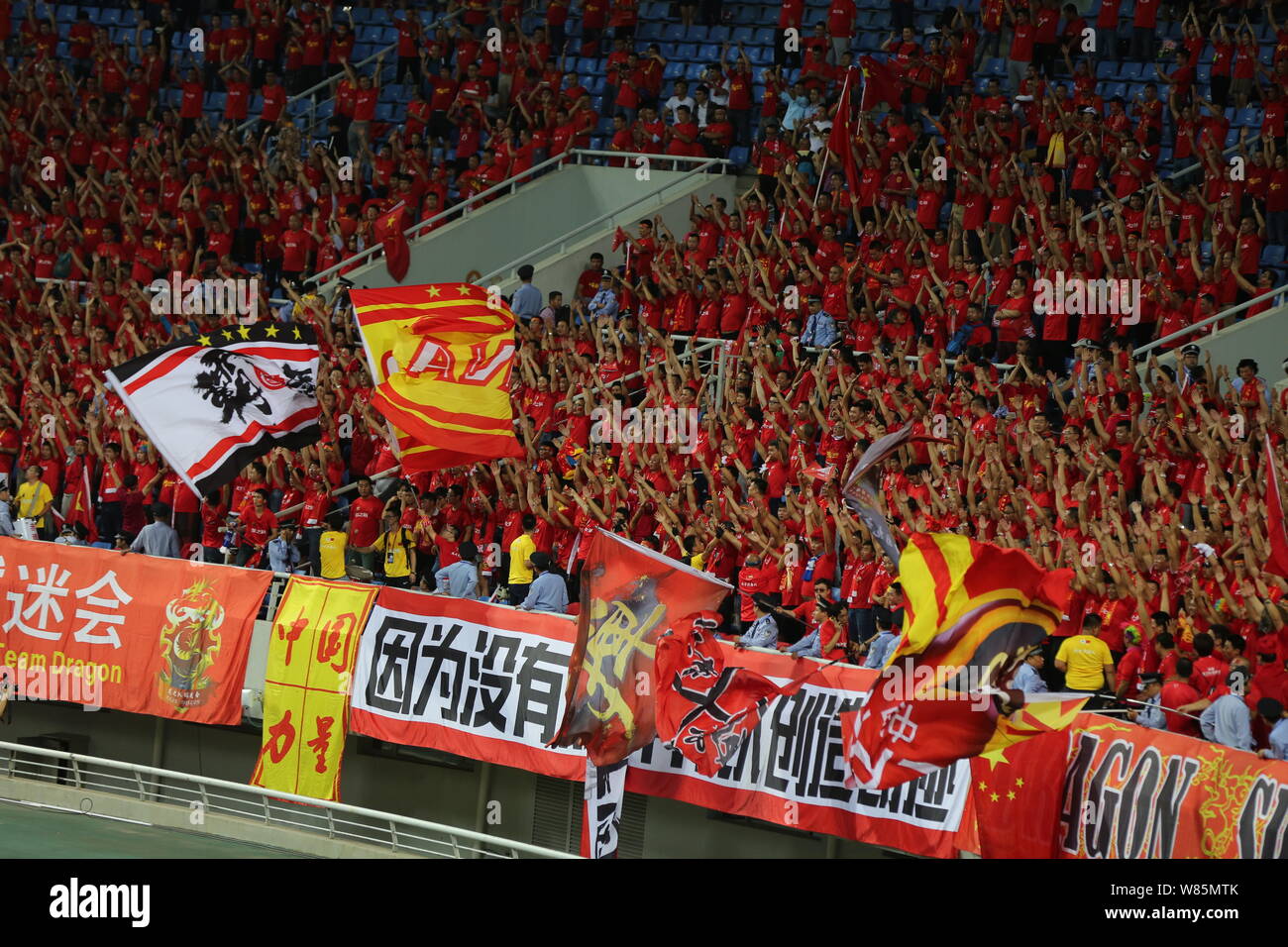 Chinese football fans shout slogans to show support for the China team ...