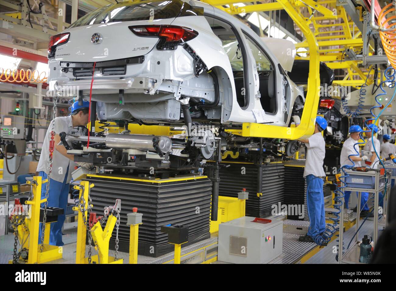 --FILE--Chinese factory workers assemble Buick cars on the assembly ...