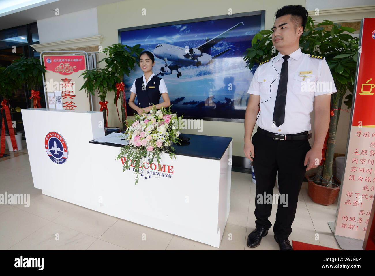 A waitress and a waiter dressed in uniforms of air hostess and pilot ...