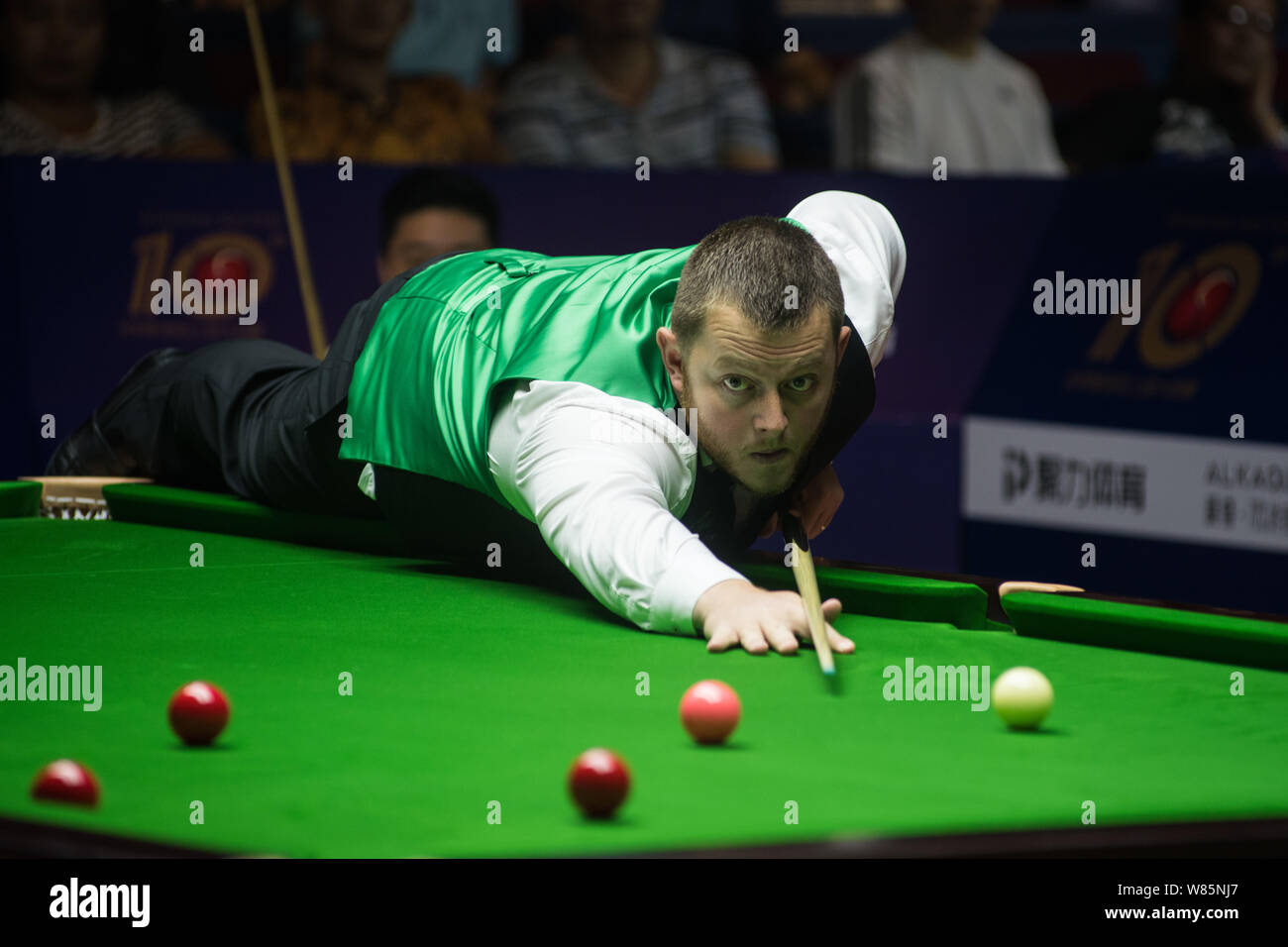Mark Allen of England plays a shot against Ding Junhui of China during ...