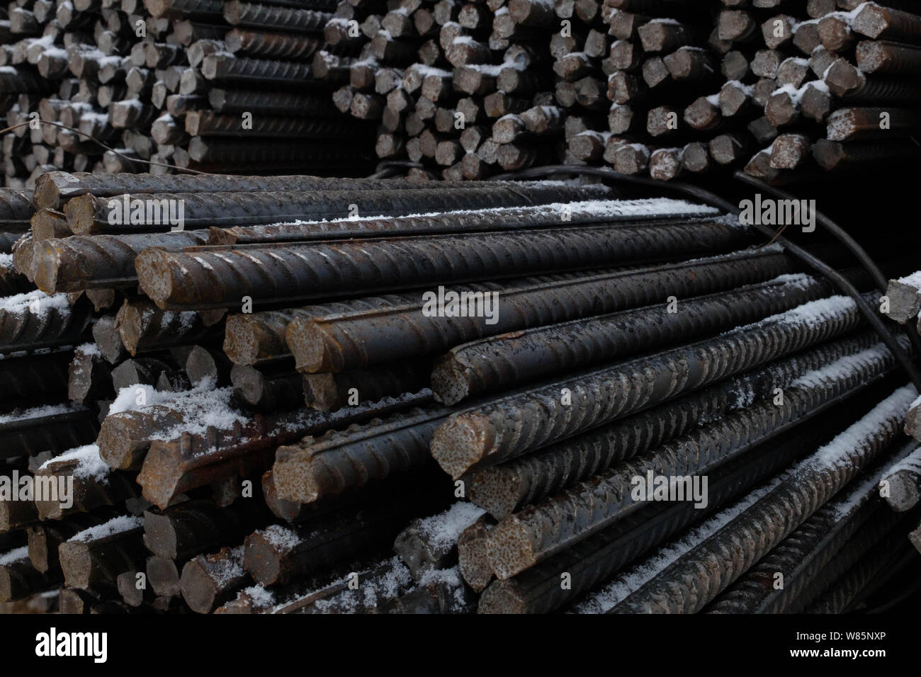 Steel snow covered reinforcement bars at the outdoor warehouse ...