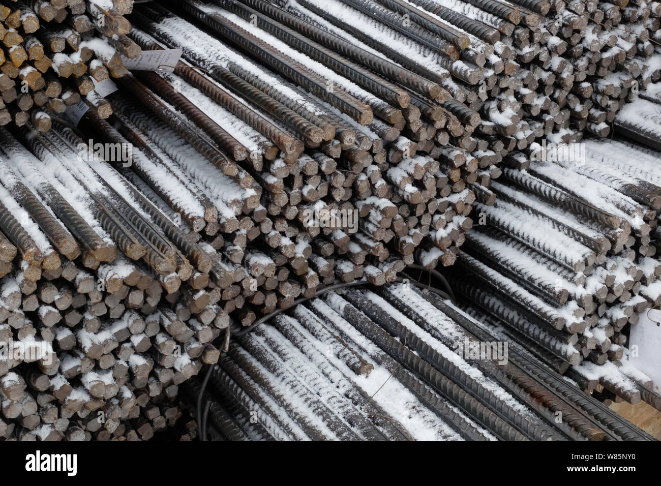 Steel snow covered reinforcement bars at the outdoor warehouse ...