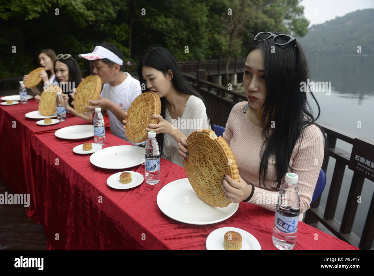 Chinese man Pan Yizhong, center, and webcasting anchors eat two ...