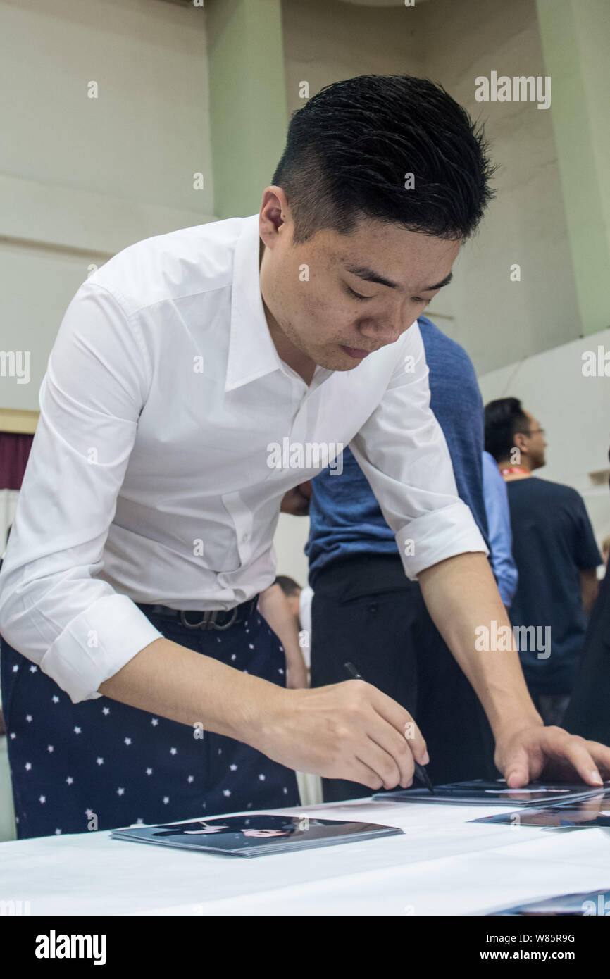 Ding Junhui of China signs autographs during the 10th anniversary for ...