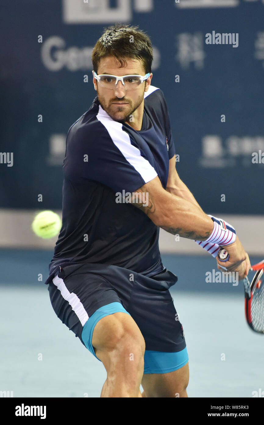 Janko Tipsarevic of Serbia returns a shot to Zhang Ze of China in their ...