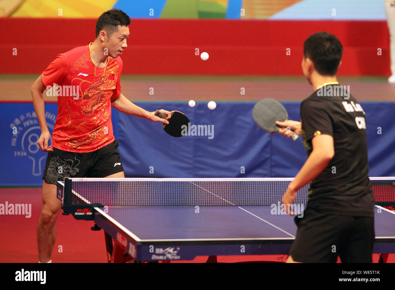 Chinese table tennis players Ma Long, front, and Xu Xin plays with ...