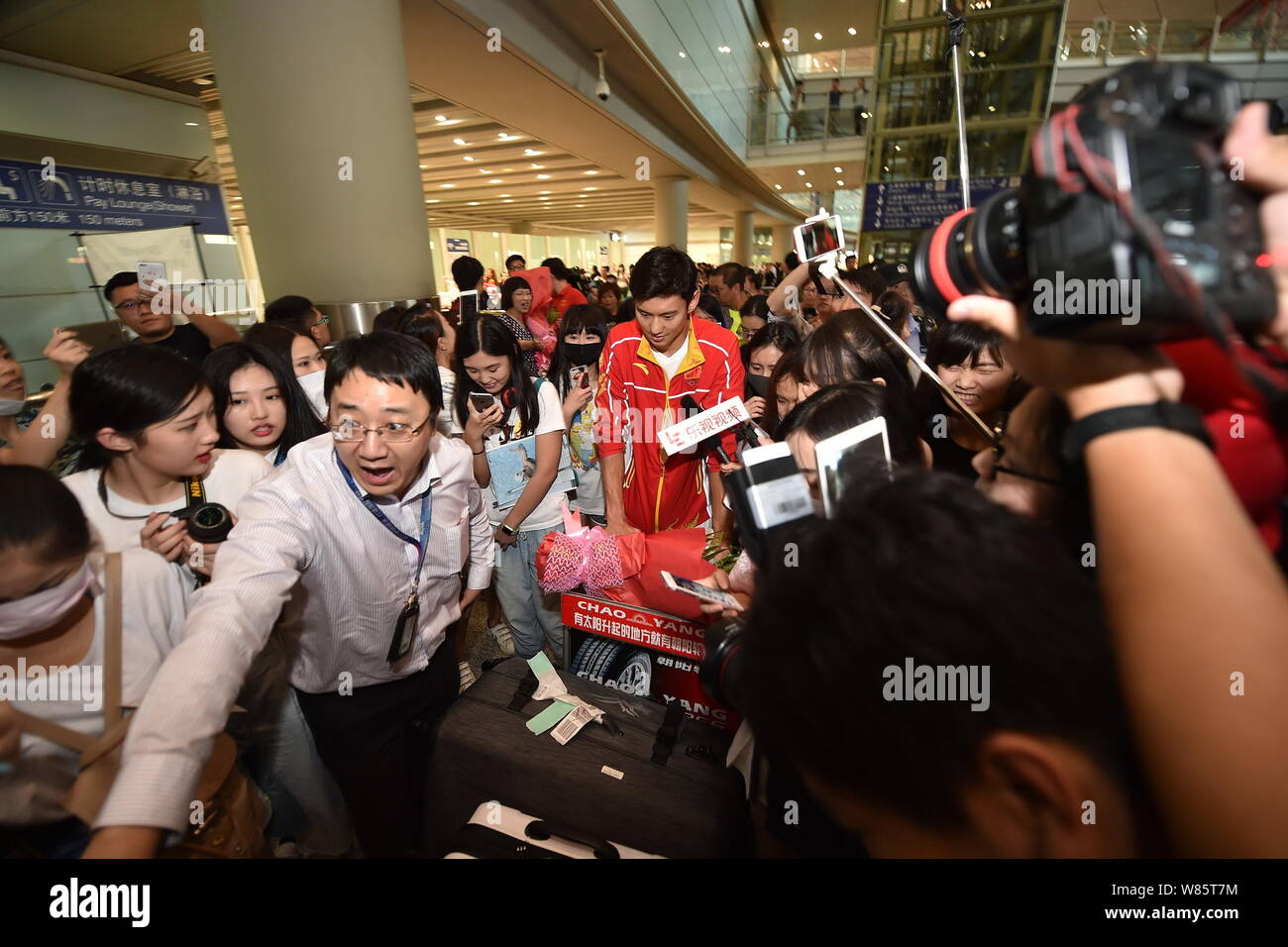 Chinese world swimming champion Ning Zetao is surrounded by fans after ...