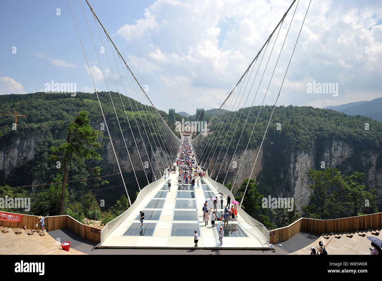 Tourists crowd the world's longest and highest glass-bottomed bridge ...