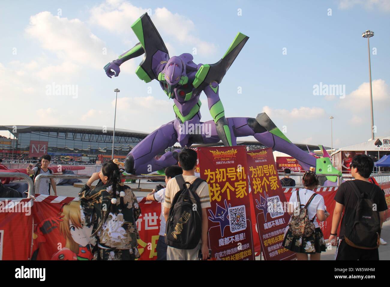 Visitors look at a giant model of Evangelion from Japanese animated ...