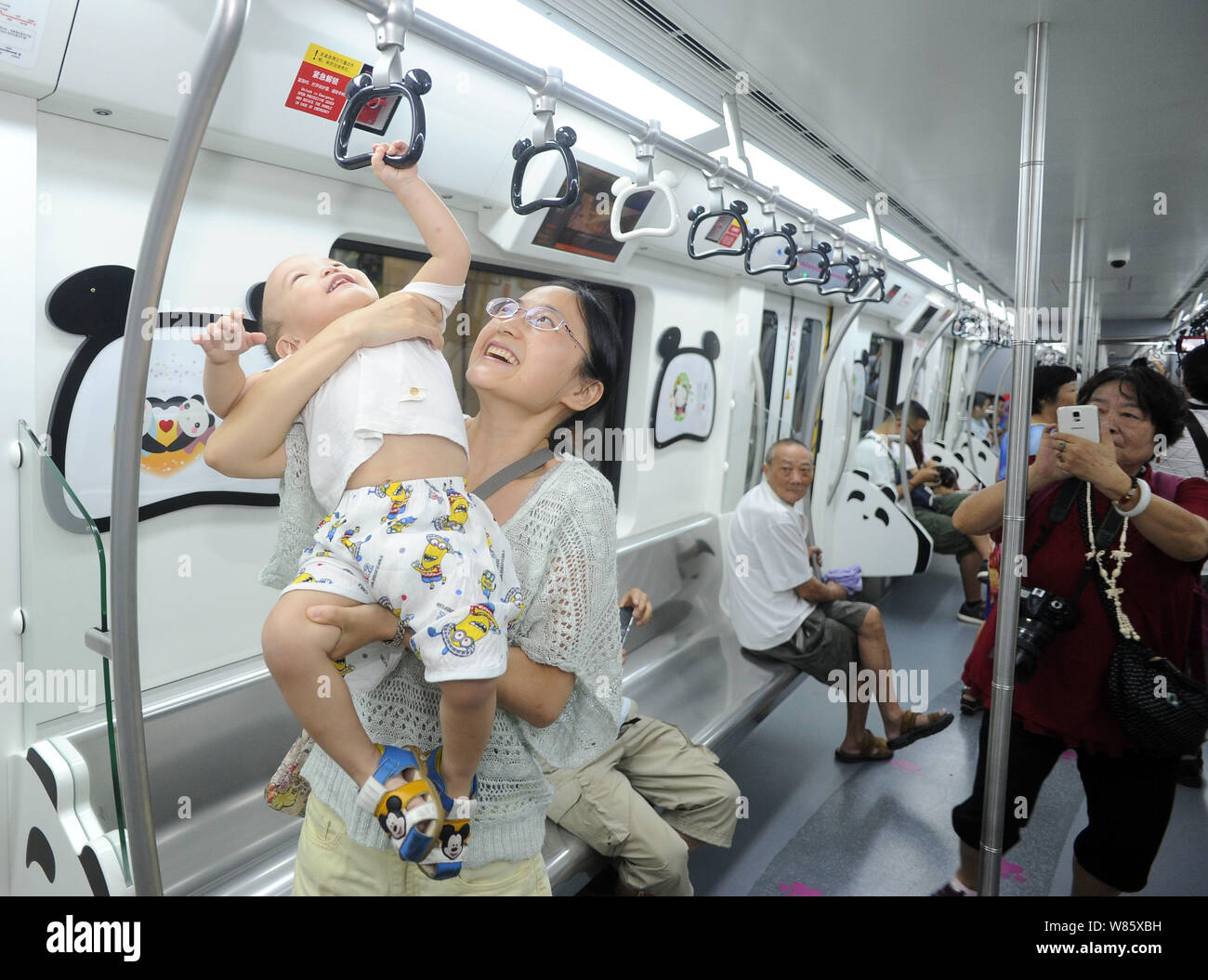 Passengers are pictured on a panda-themed subway train of subway Line 3 ...