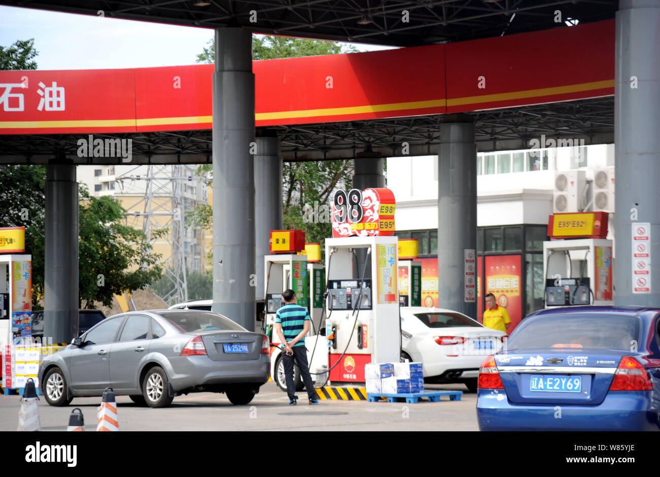 --FILE--Cars are being refueled at a gas station of PetroChina, a ...
