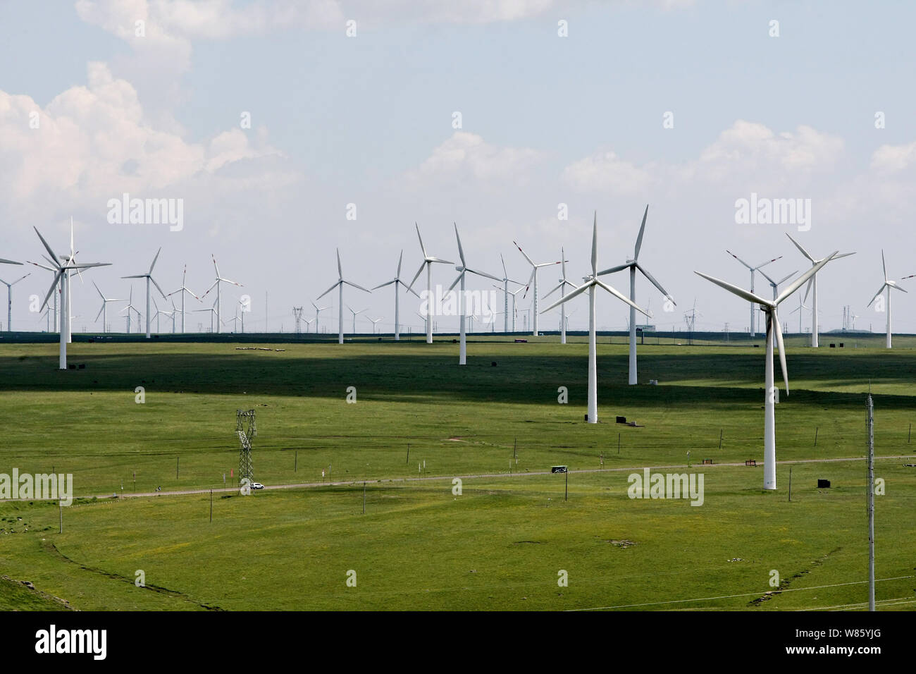 --FILE--Wind turbines whirl to generate electricity at a wind farm in ...