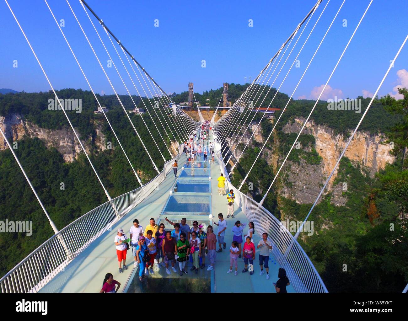 Tourists crowd the world's longest and highest glass-bottomed bridge ...