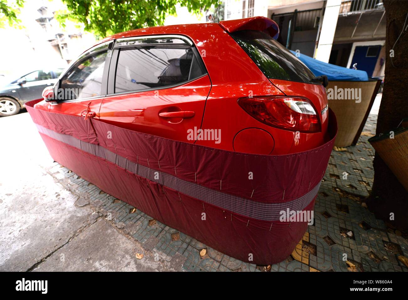 Cars are encircled by makeshift shields to prevent rats from invasion ...
