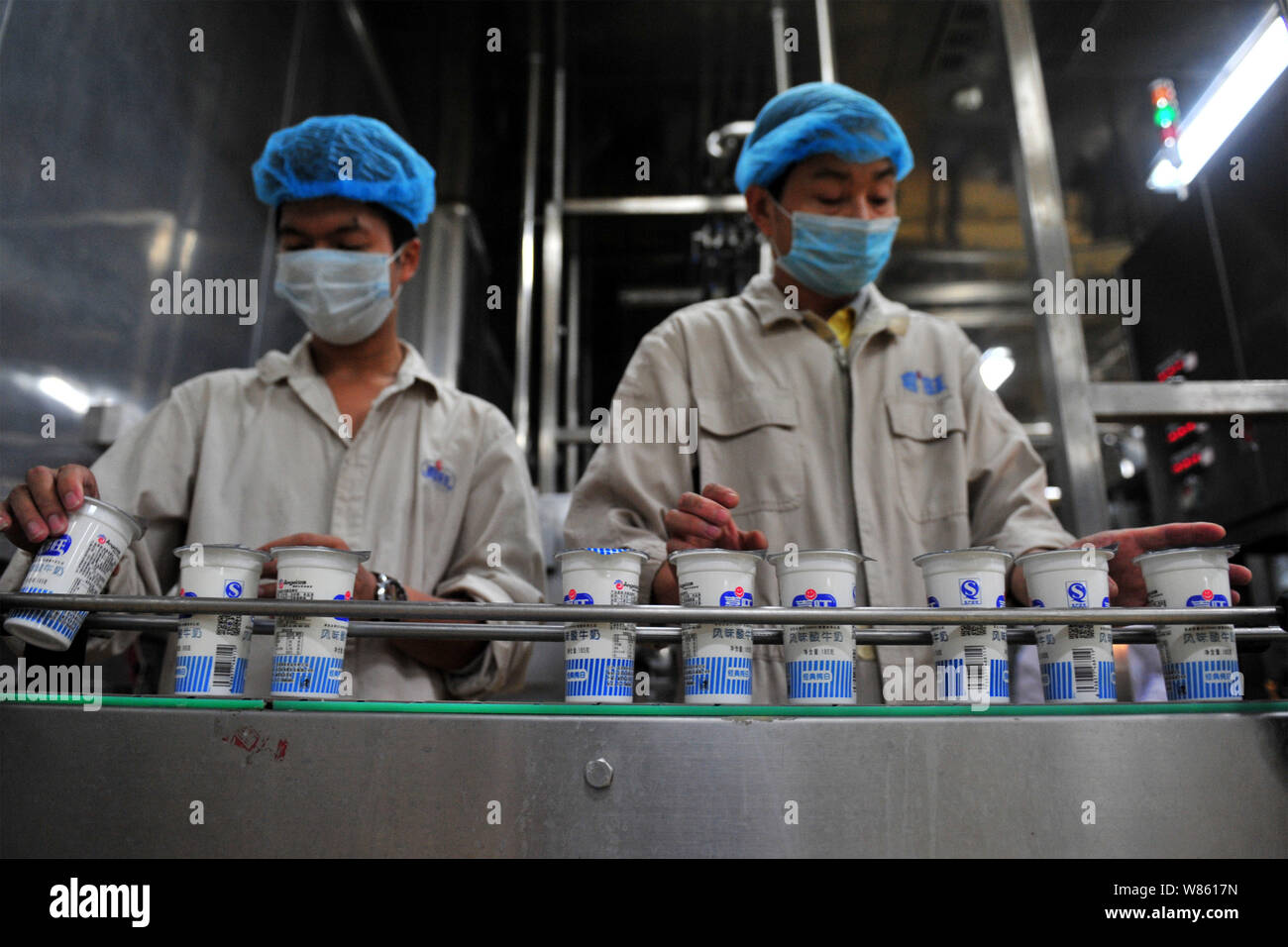 --FILE--Chinese workers produce yoghourt on an assembly line at a food ...