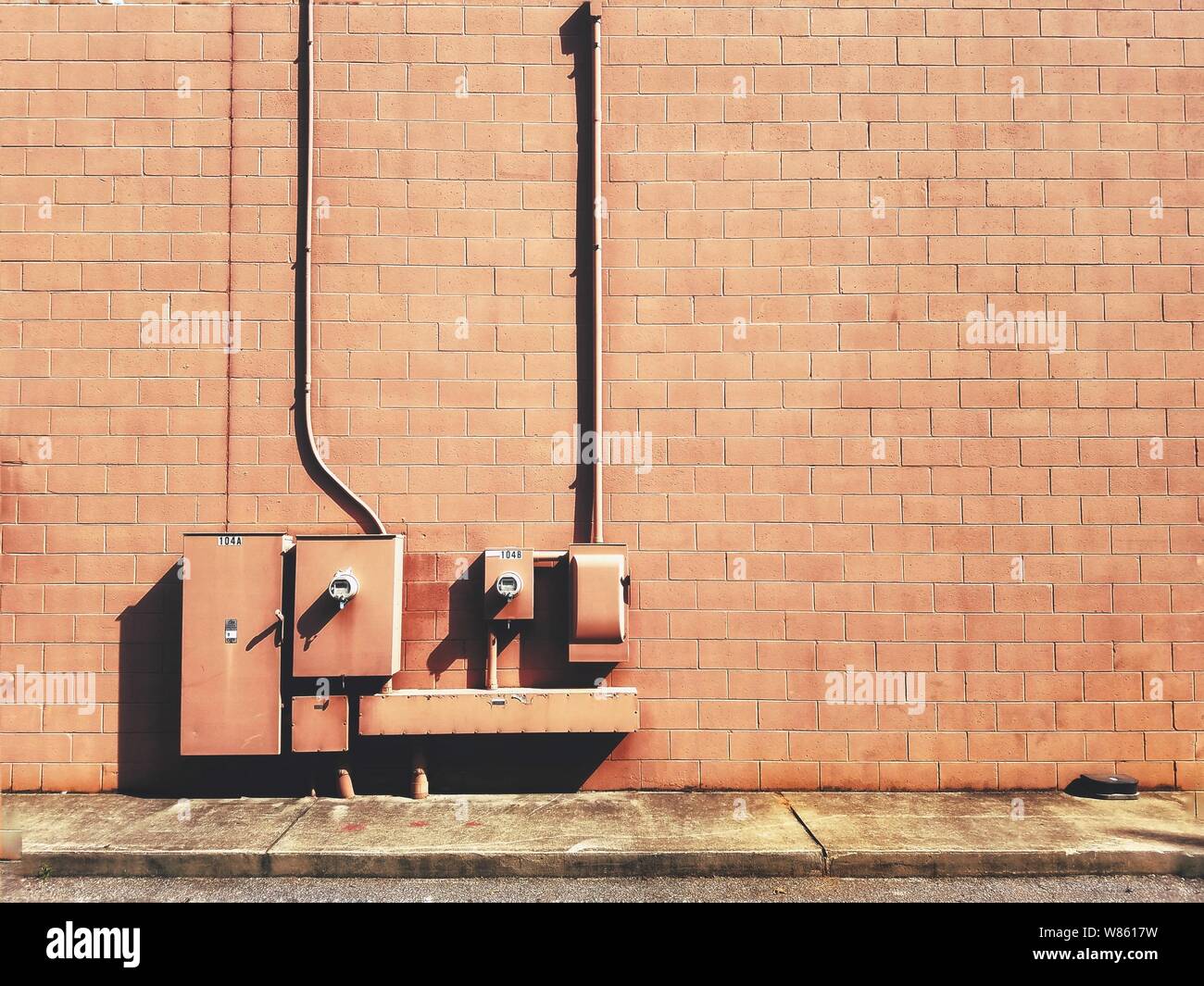 Closeup of electrical fuse boxes on a brown brick wall Stock Photo - Alamy
