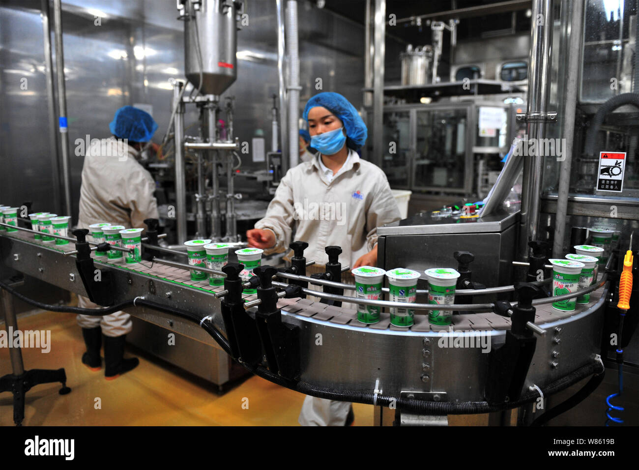 --FILE--Chinese workers produce yoghourt on an assembly line at a food ...
