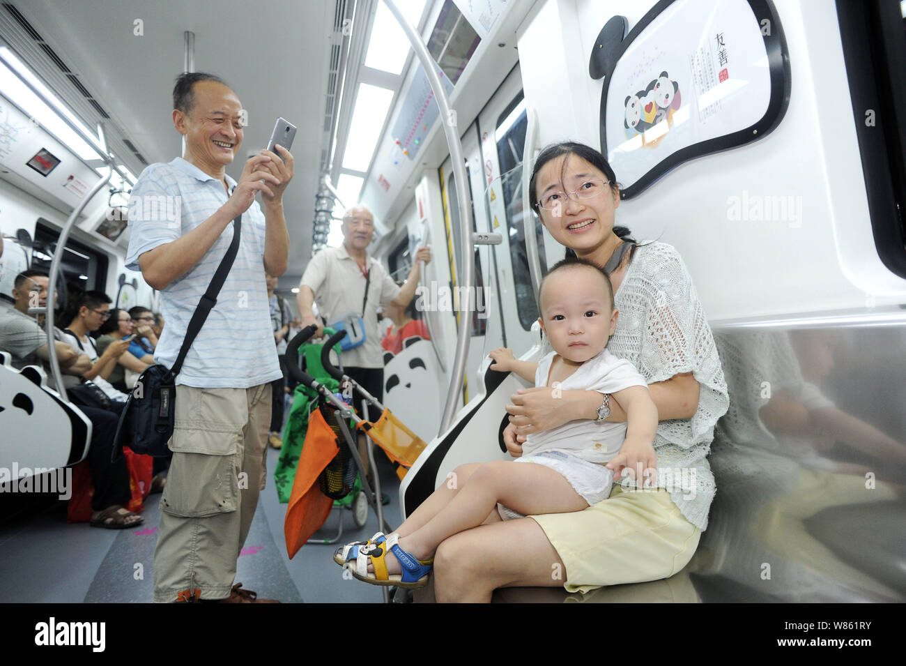 Passengers are pictured on a panda-themed subway train of subway Line 3 ...